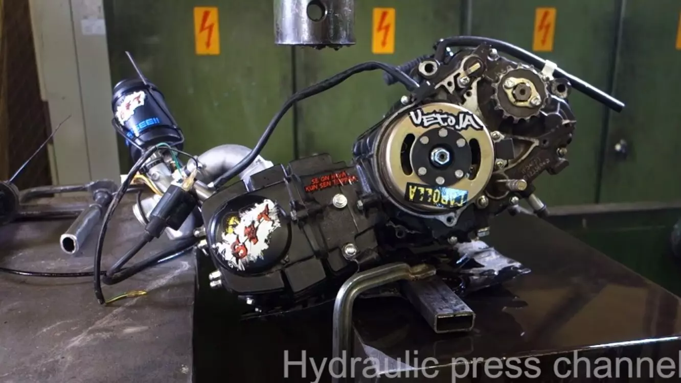 Hydraulic press against motorcycle helmet 344060_3