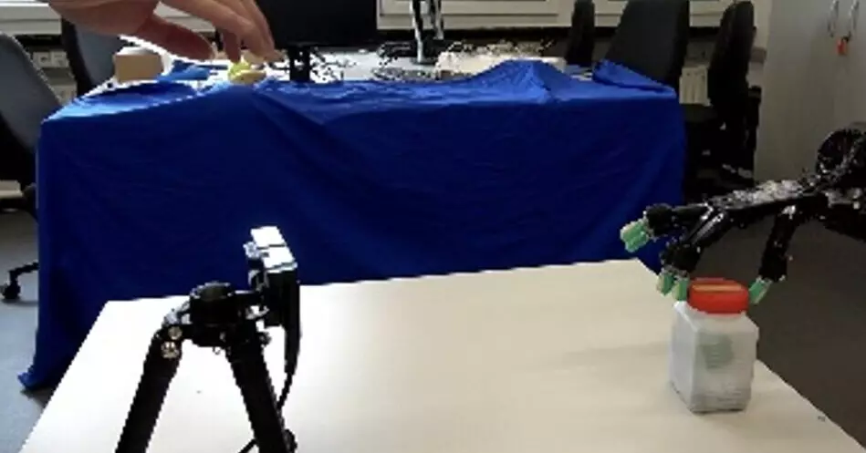 The robot learns to work with its hand by watching how a person does it